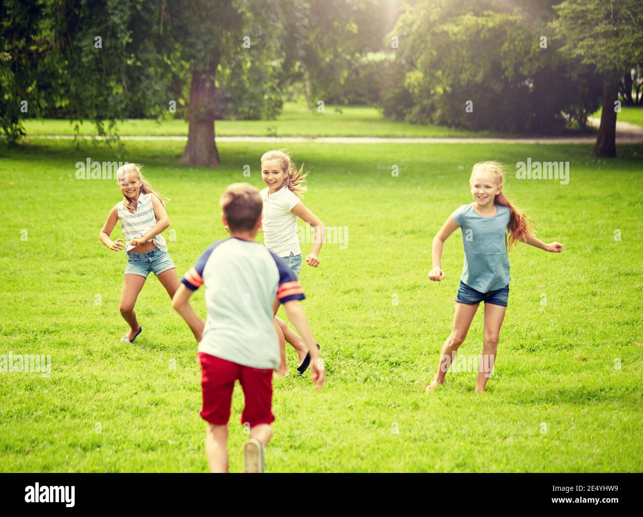 happy kids running and playing game outdoors Stock Photo - Alamy