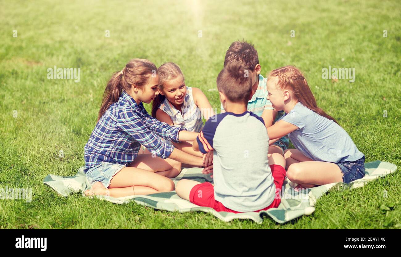 group of happy kids putting hands together Stock Photo - Alamy