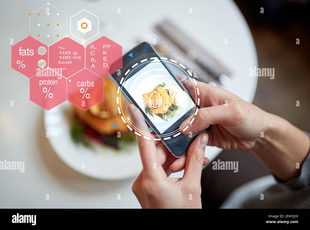 hands with phone and food nutritional value chart Stock Photo - Alamy