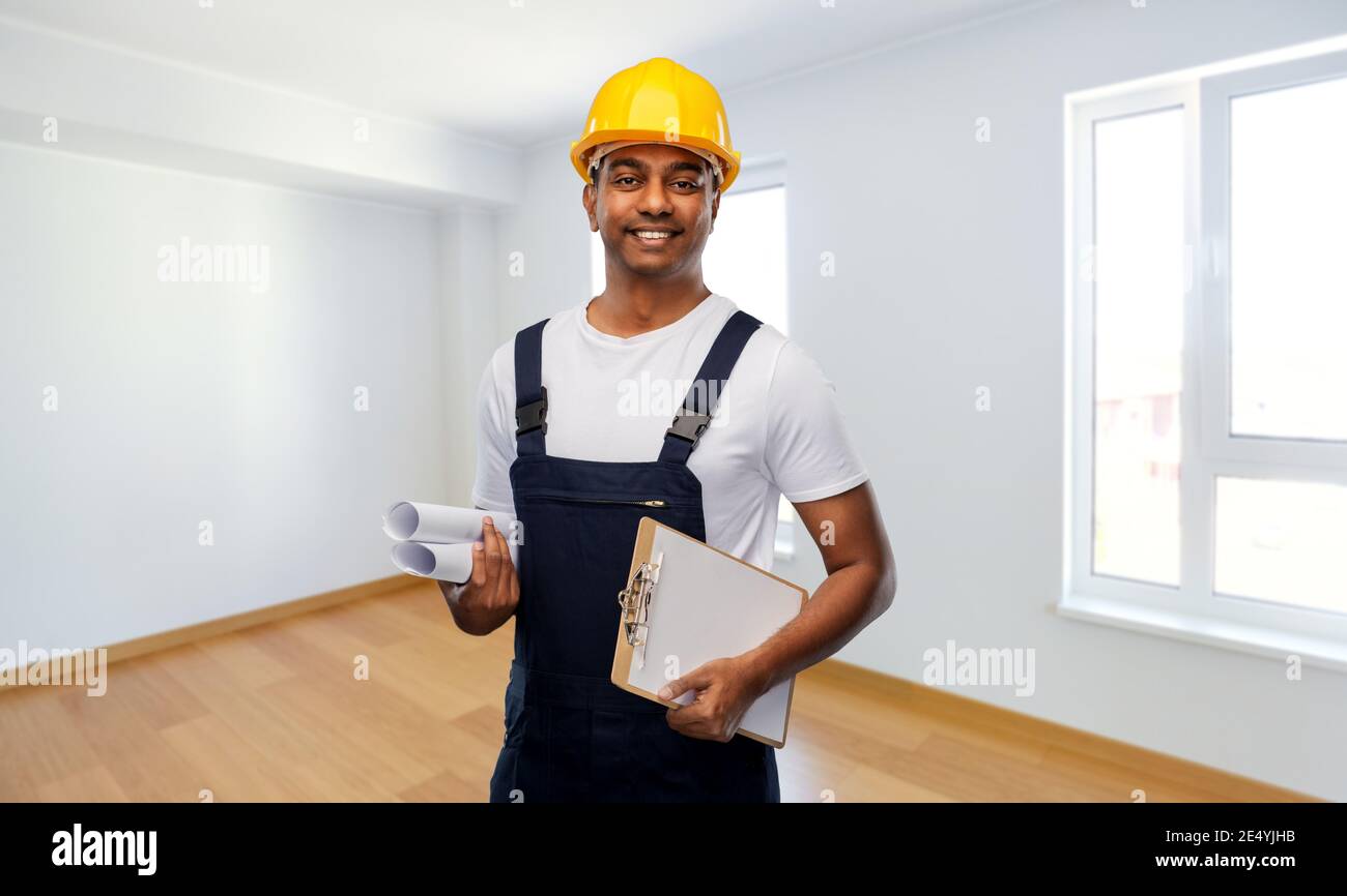 happy indian builder with blueprint and clipboard Stock Photo - Alamy