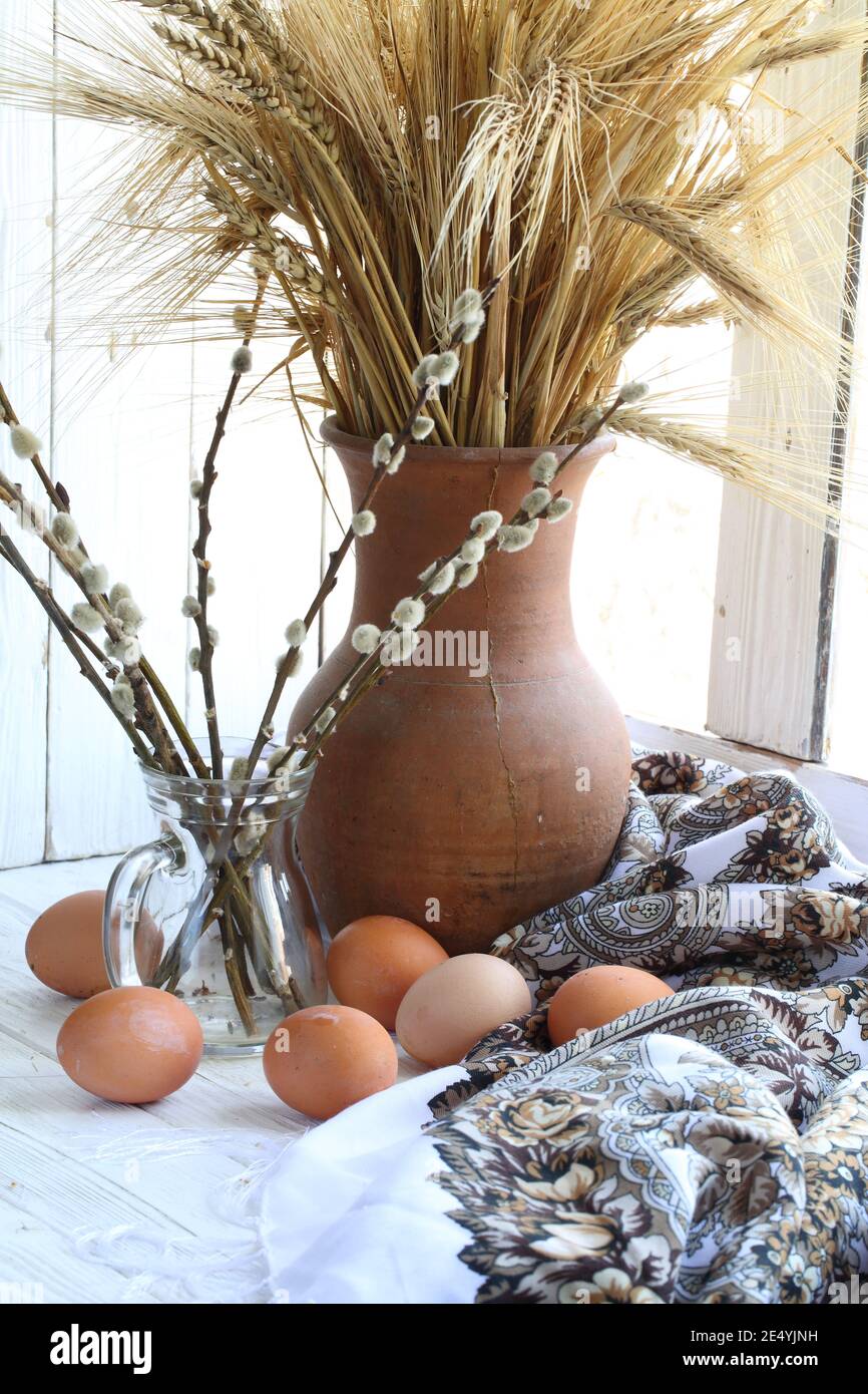 Easter still life with willow, wheat, painted eggs on a wooden background Stock Photo - Alamy