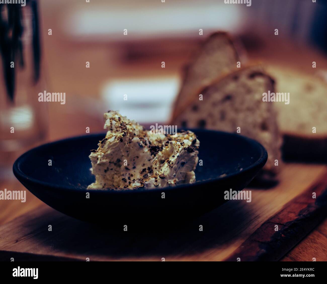 Bread and butter on a wooden plate at a restaurant Stock Photo - Alamy