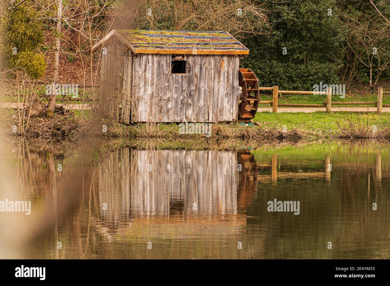 Calm rural scenery with a small wooden cabin by the lake Stock Photo ...