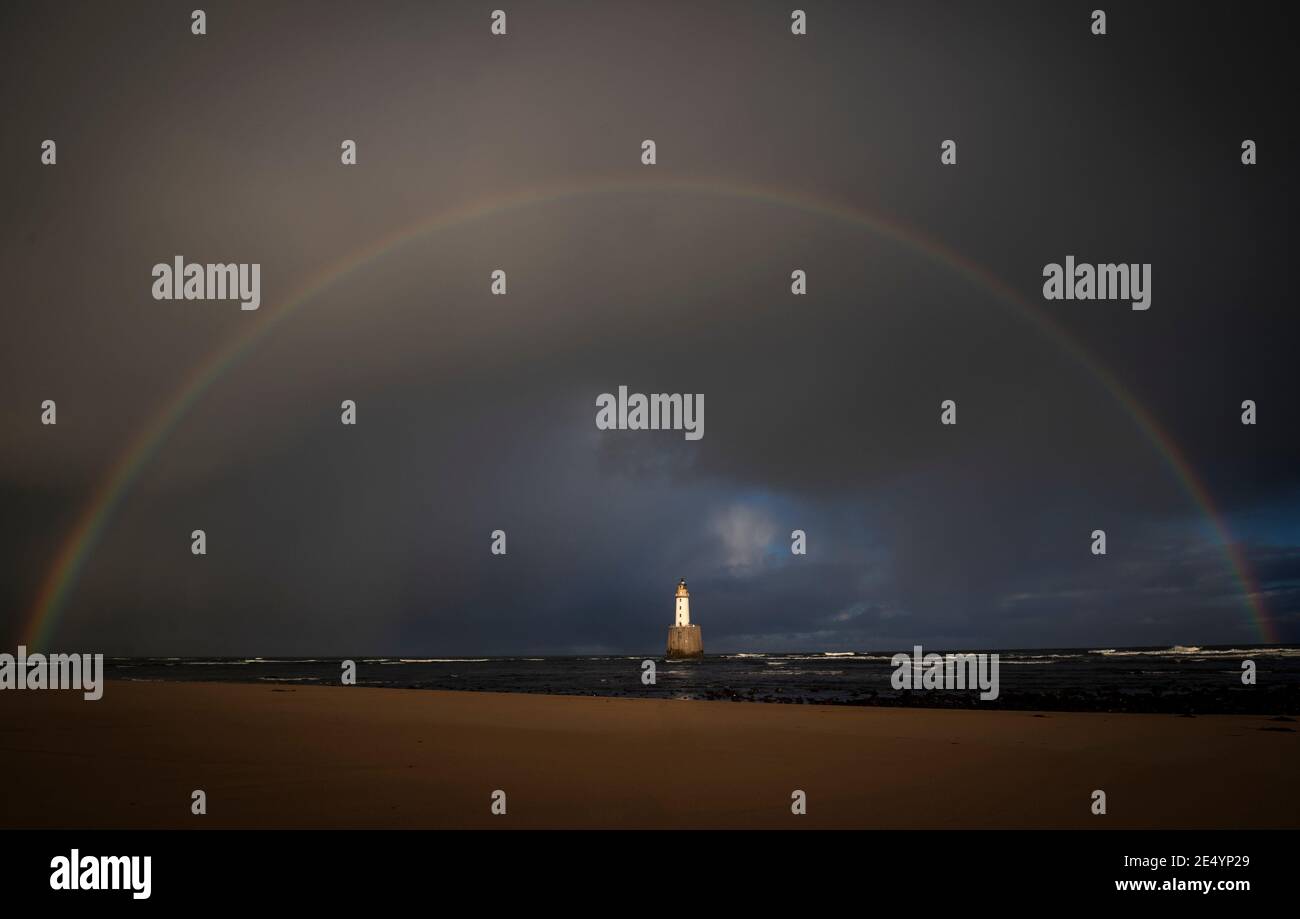A rainbow forms over the North Sea above Rattray Head Lighthouse, near ...