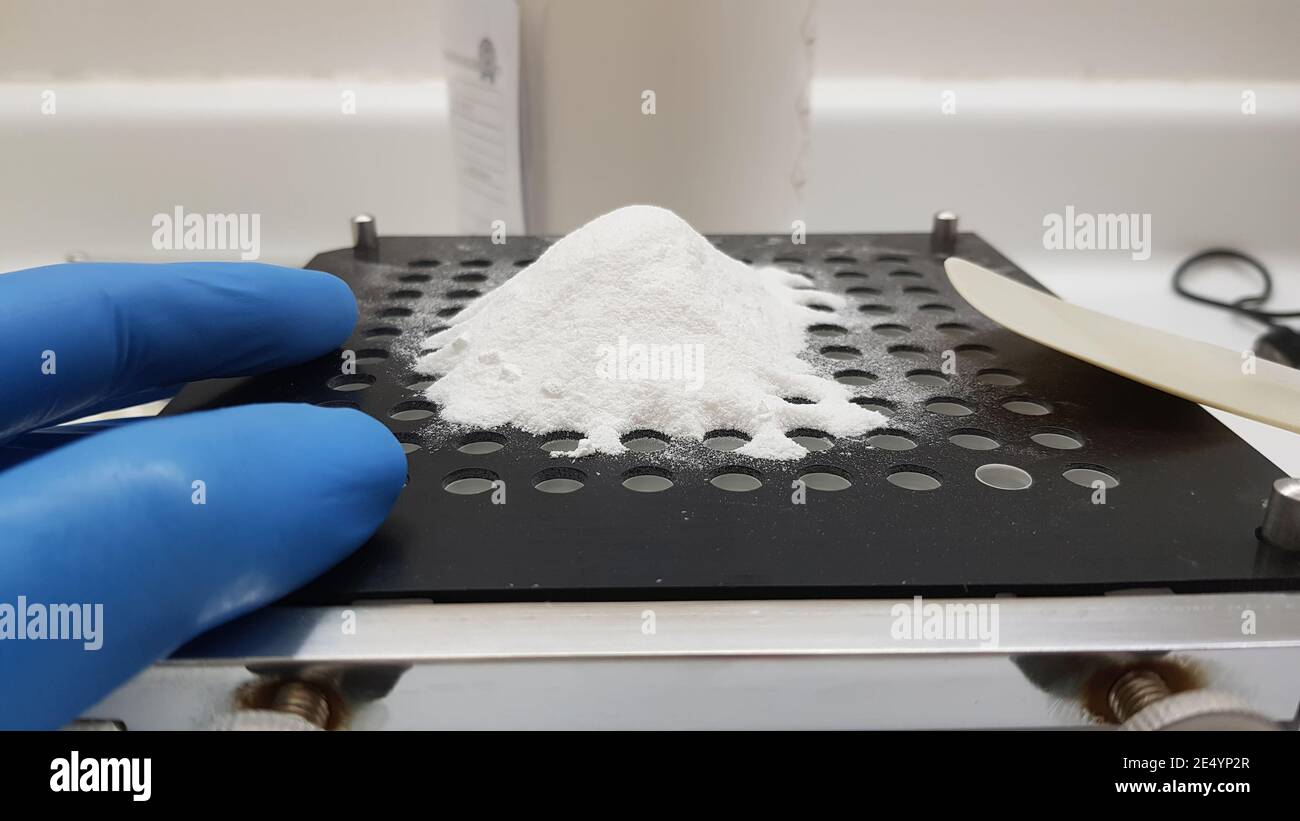 Scientist making capsules with powder medicine in the pharmacy ...