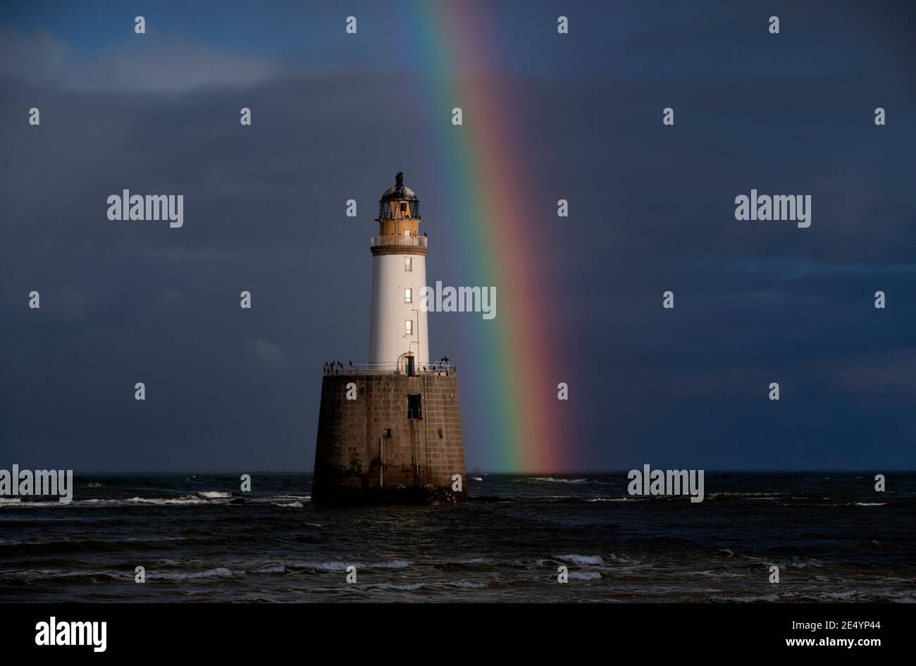 A rainbow forms over the North Sea above Rattray Head Lighthouse, near ...