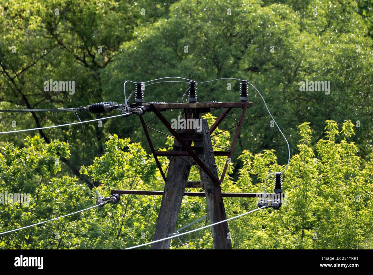 Power line with live wires. Electric poles with ceramic cable ...