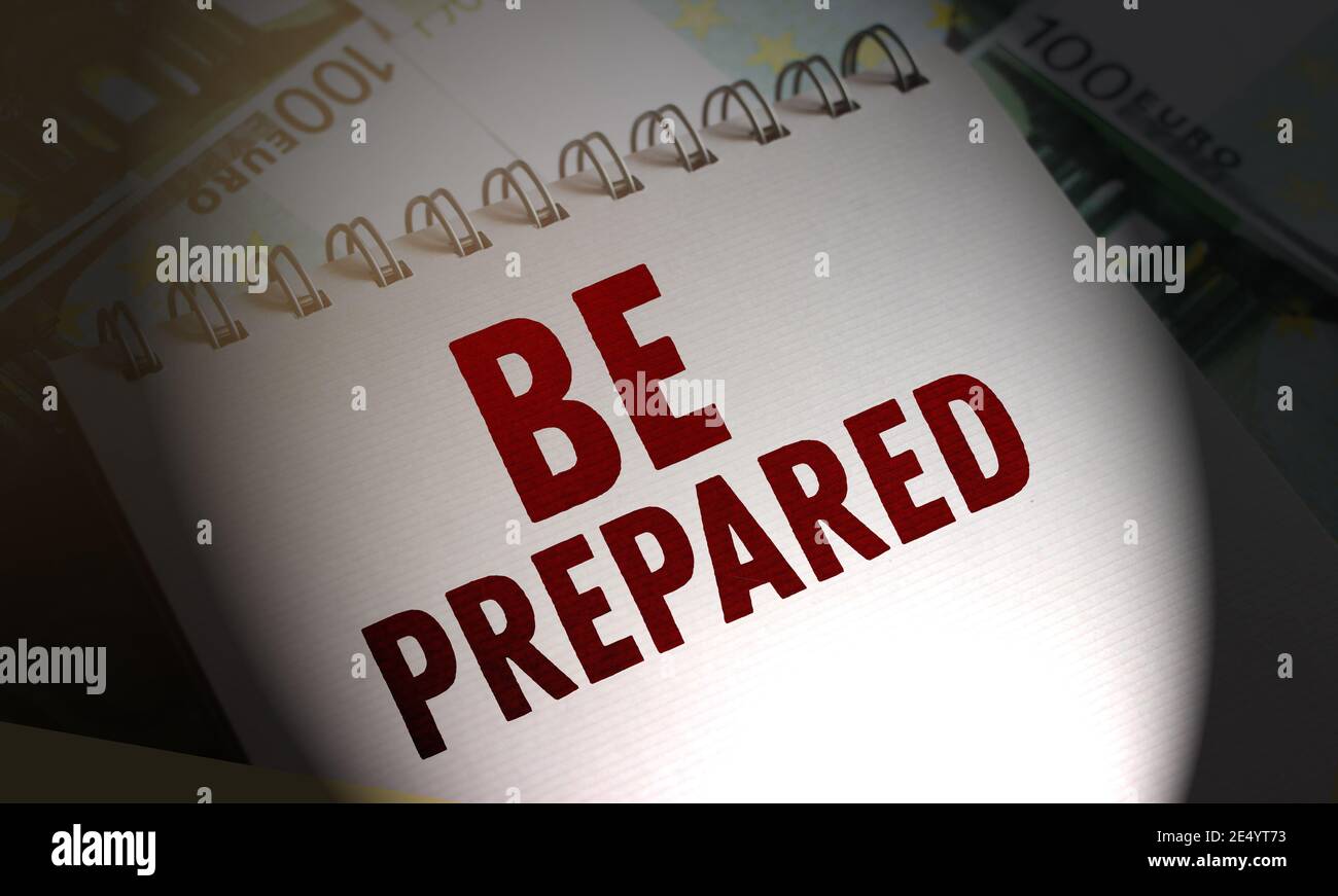 Be prepared words on page of copybook laying on 100 Euro banknotes ...