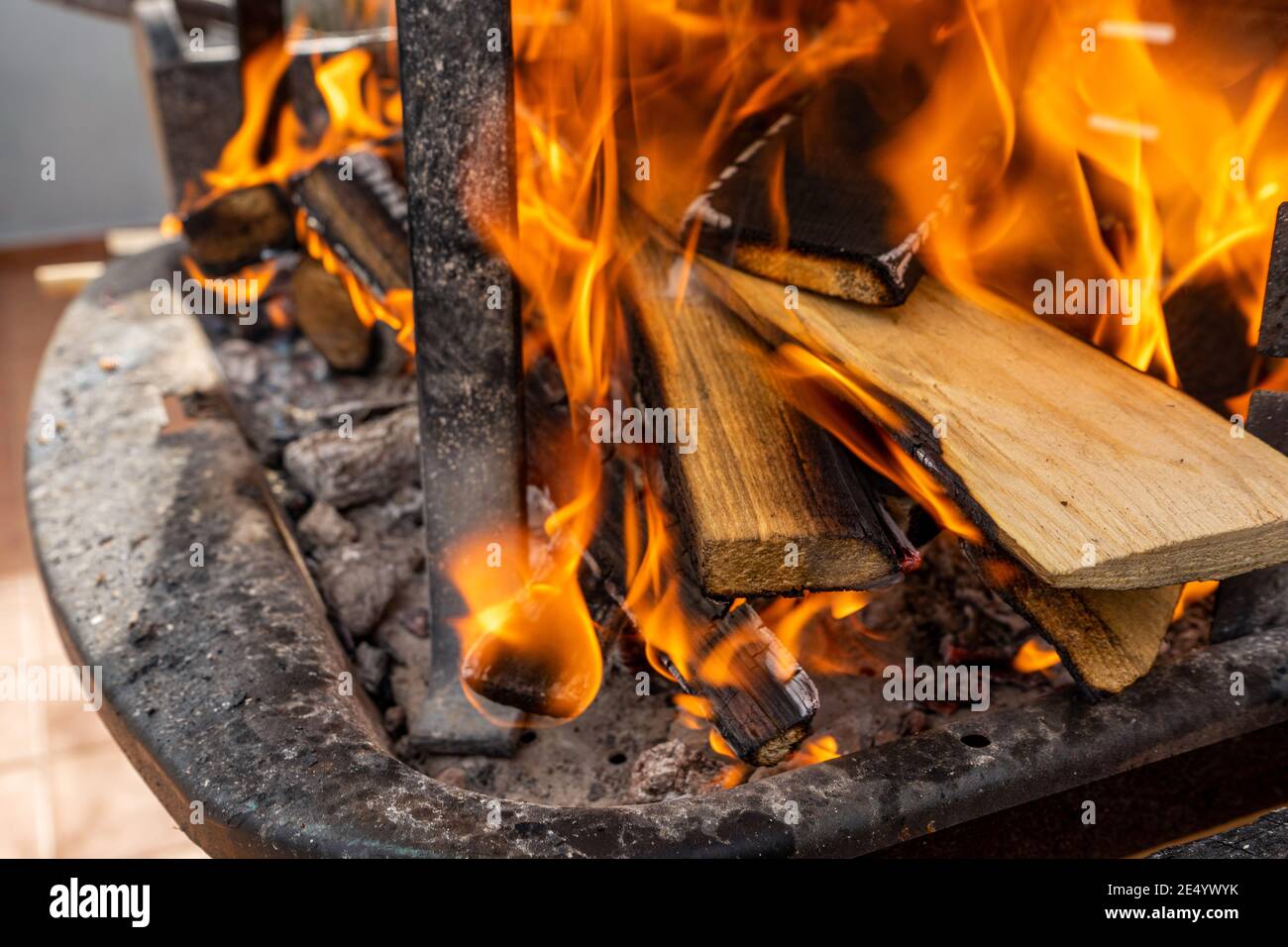 Flames in different forms of a bonfire made with orange tree trunks ...