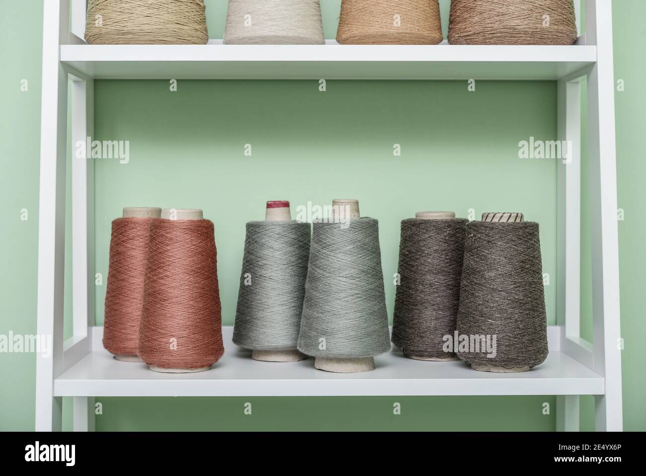 Set of colored threads for knitting on cone. Pile of big colorful ...