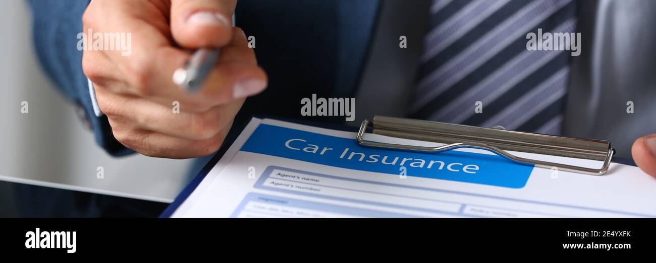 Man is holding car insurance claim form Stock Photo - Alamy