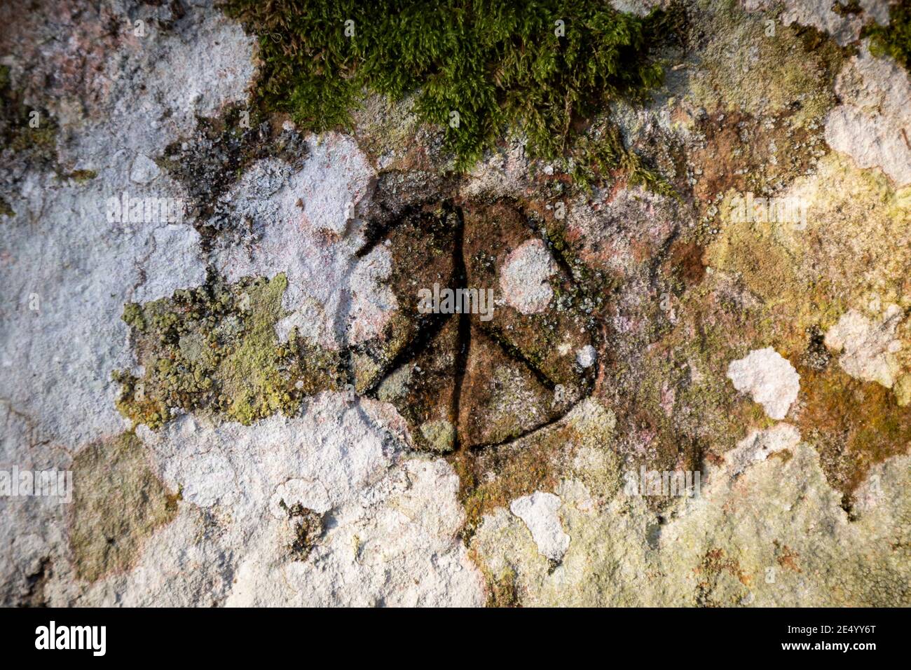 peace sign carved into rock Stock Photo - Alamy