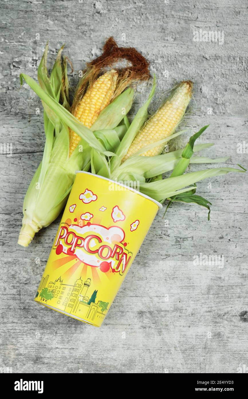 Fresh corns in paper container on stone background Stock Photo - Alamy