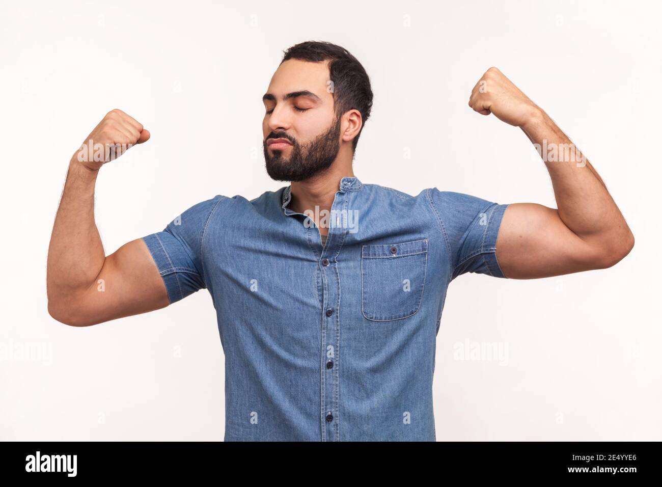 Strong and independent self confident man with beard showing biceps ...