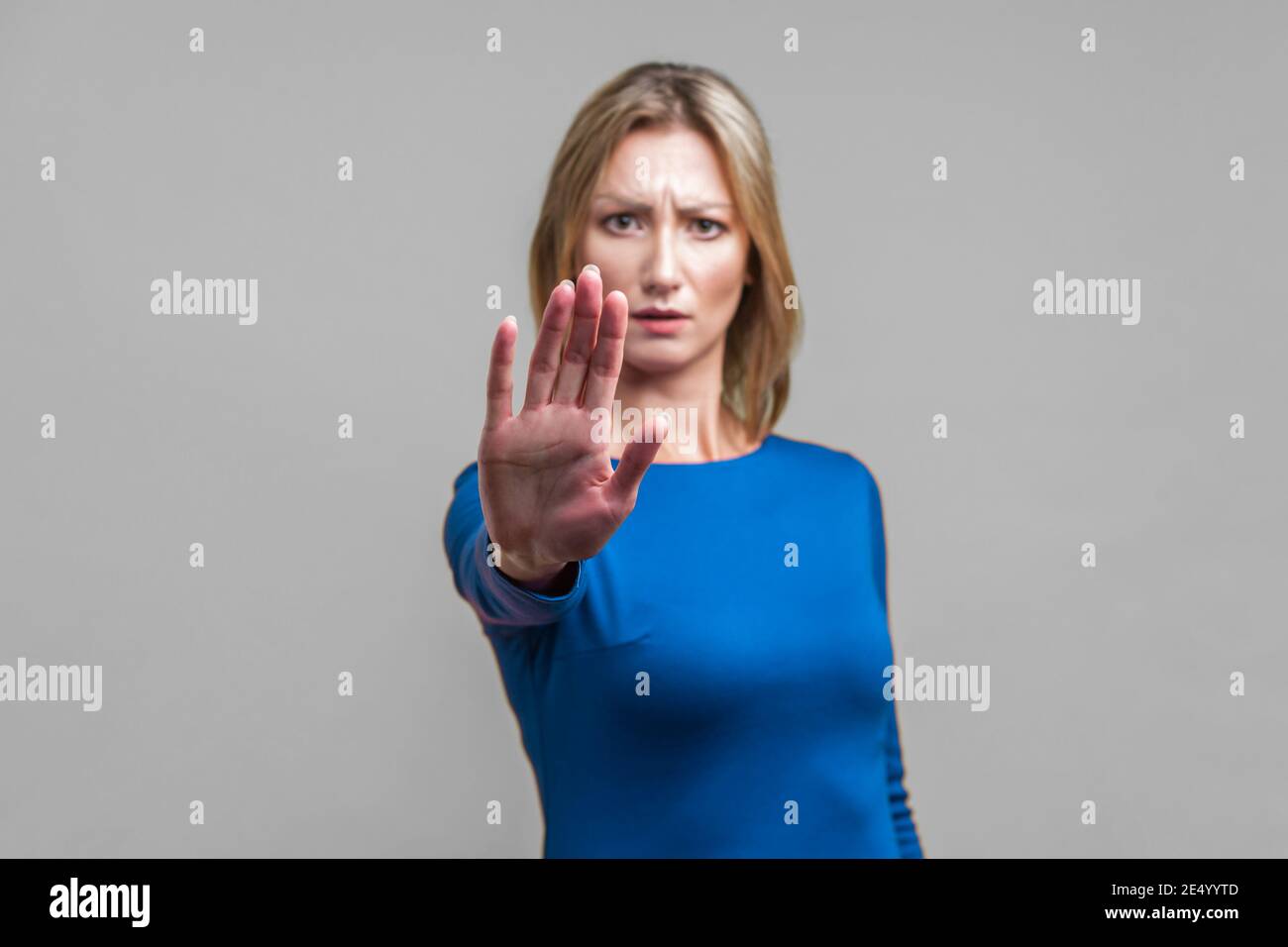 No, forbidden! Portrait of upset young woman in tight blue dress ...