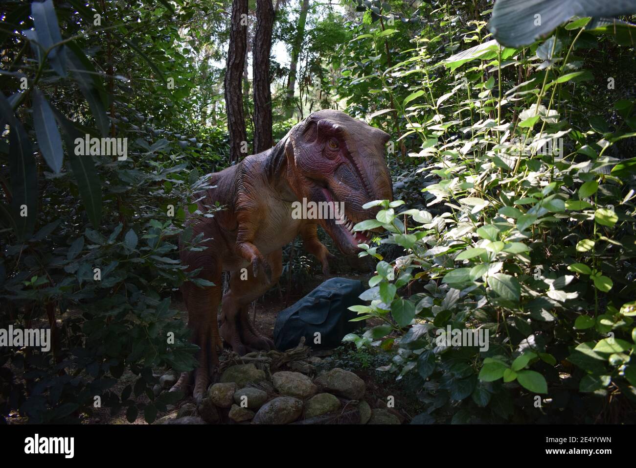 Dinosaur statue in the forest park in nature for background. Realistic ...