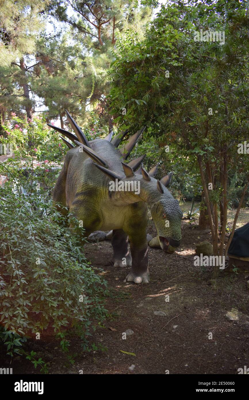 Dinosaur statue in the forest park. Stegosaurus, replicas of a ...