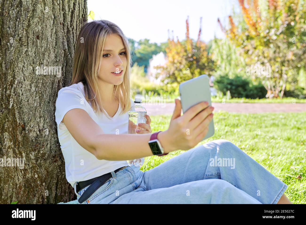 Female student teenager looking at smartphone screen laughing talking ...