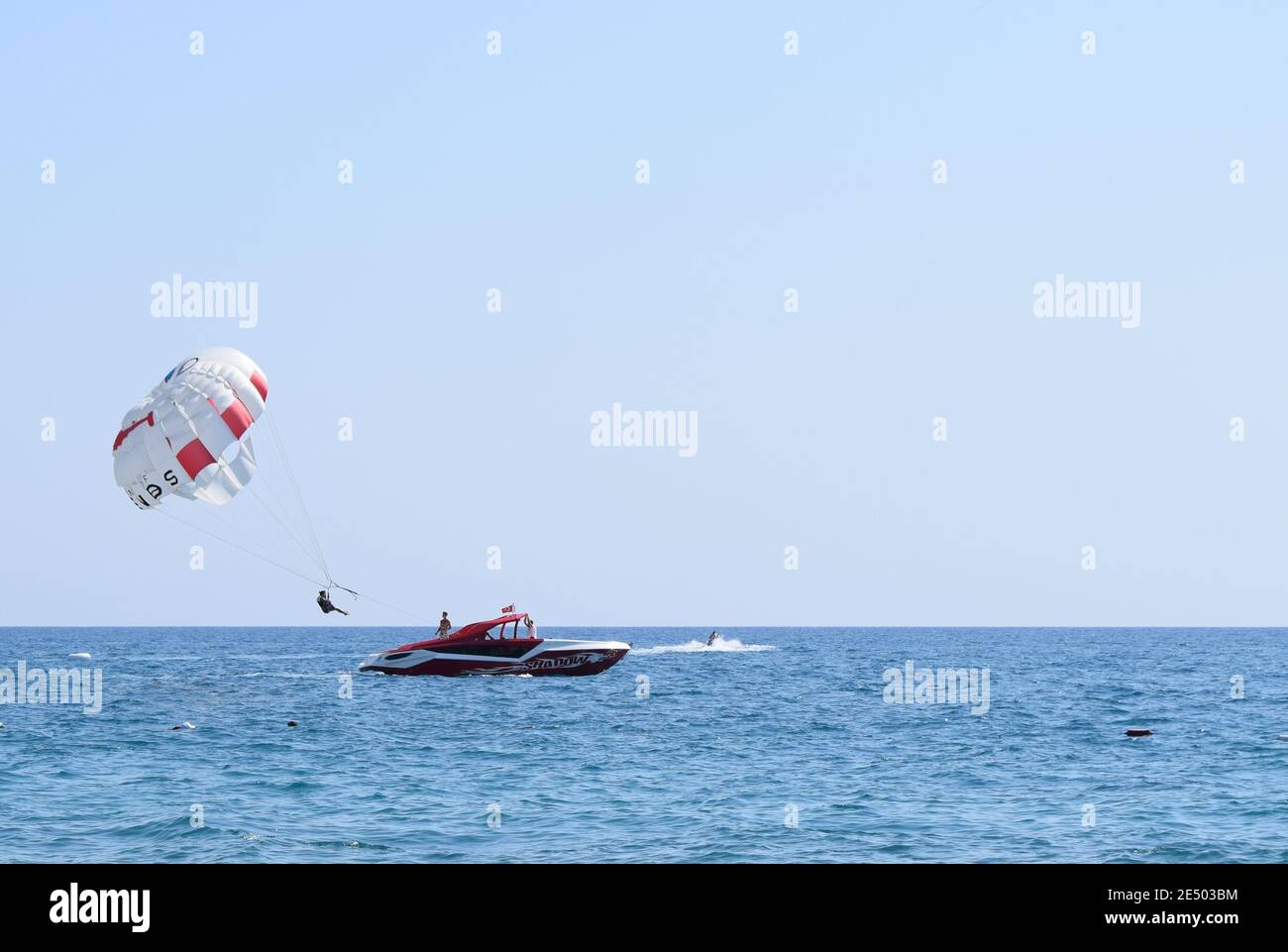 Parasailing water amusement - flying on a parachute behind a boat on a ...