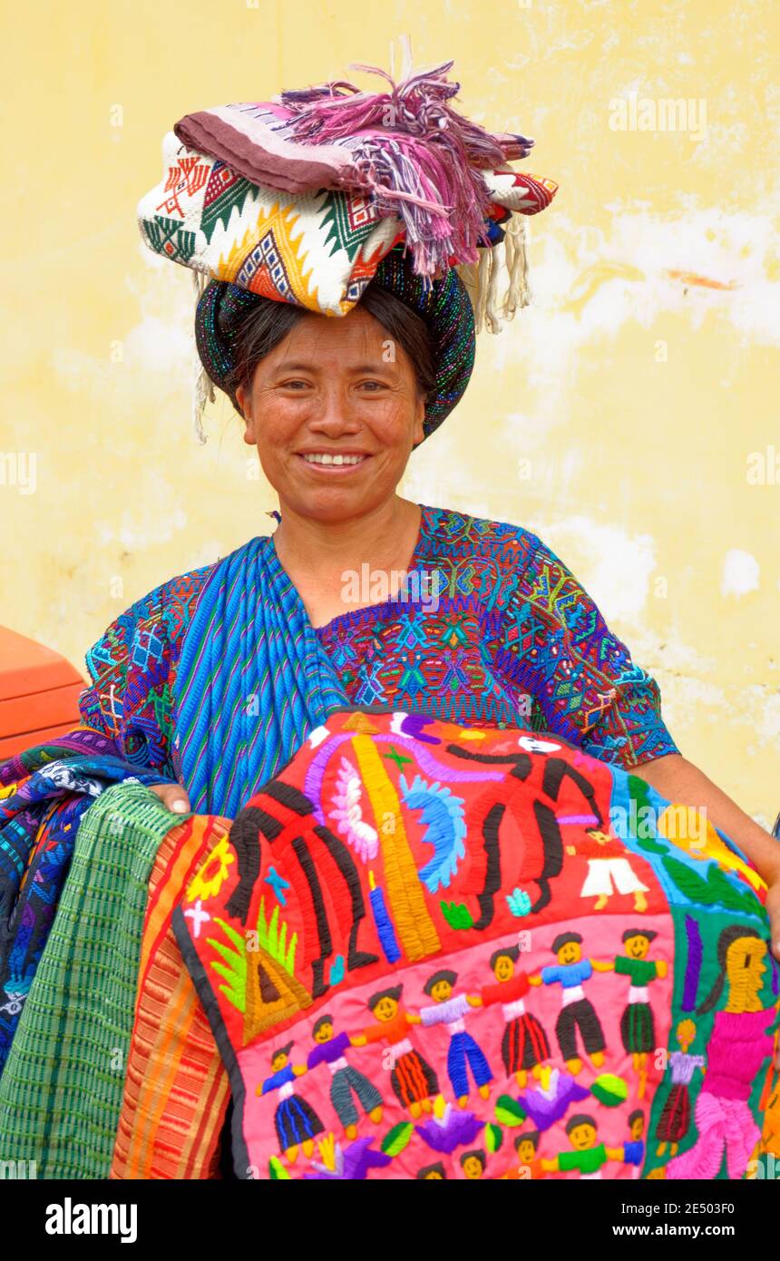 Mayan Indian woman wearing a traditional huipil sells weavings in the ...