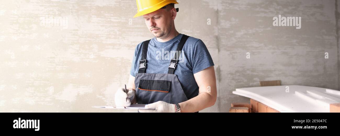 Engineer in work clothes and safety helmet Stock Photo - Alamy
