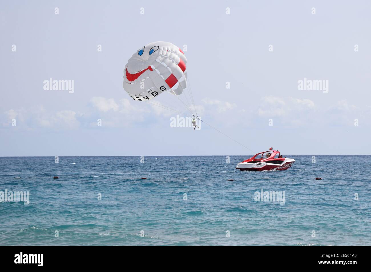 Funny parasail wing pulled by a boat. Sea summer recreation. Sky clear ...