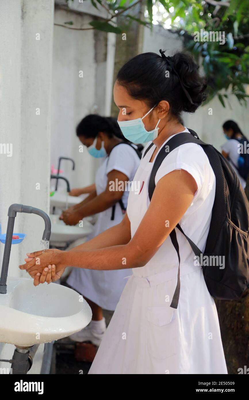 Colombo, Sri Lanka. 25th Jan, 2021. Students wash their hands at a ...