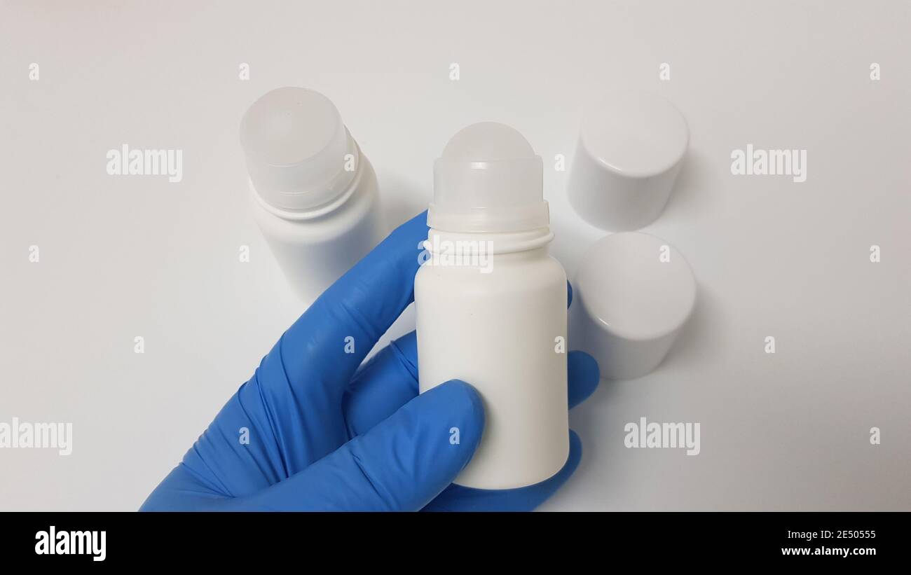 Cosmetic technician showing a deodorant and antiperspirant rollon ...