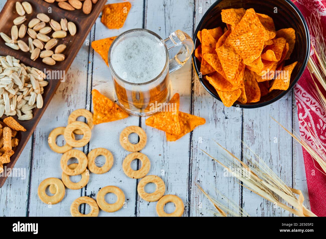 Assorted snacks, chips, and beer on blue table. Table for group of ...