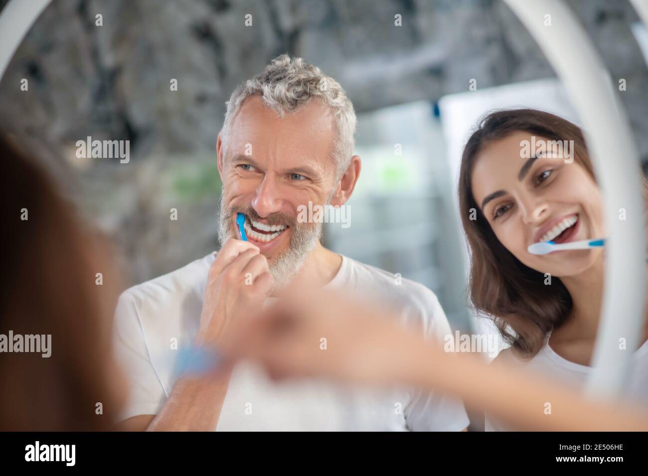 Man and woman enjoying brushing their teeth together Stock Photo - Alamy