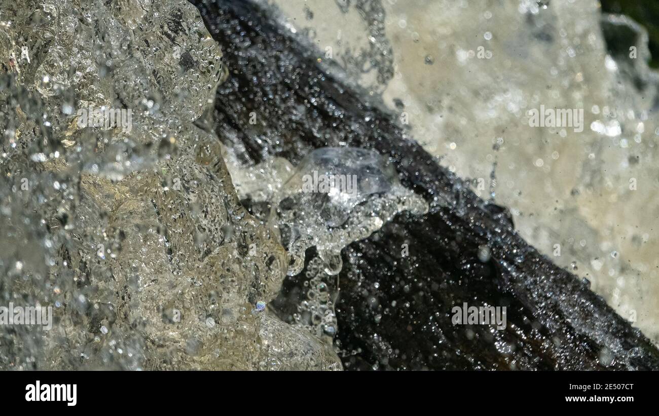 Water backgrounds with foam spray fast flow.The log is stuck in ...