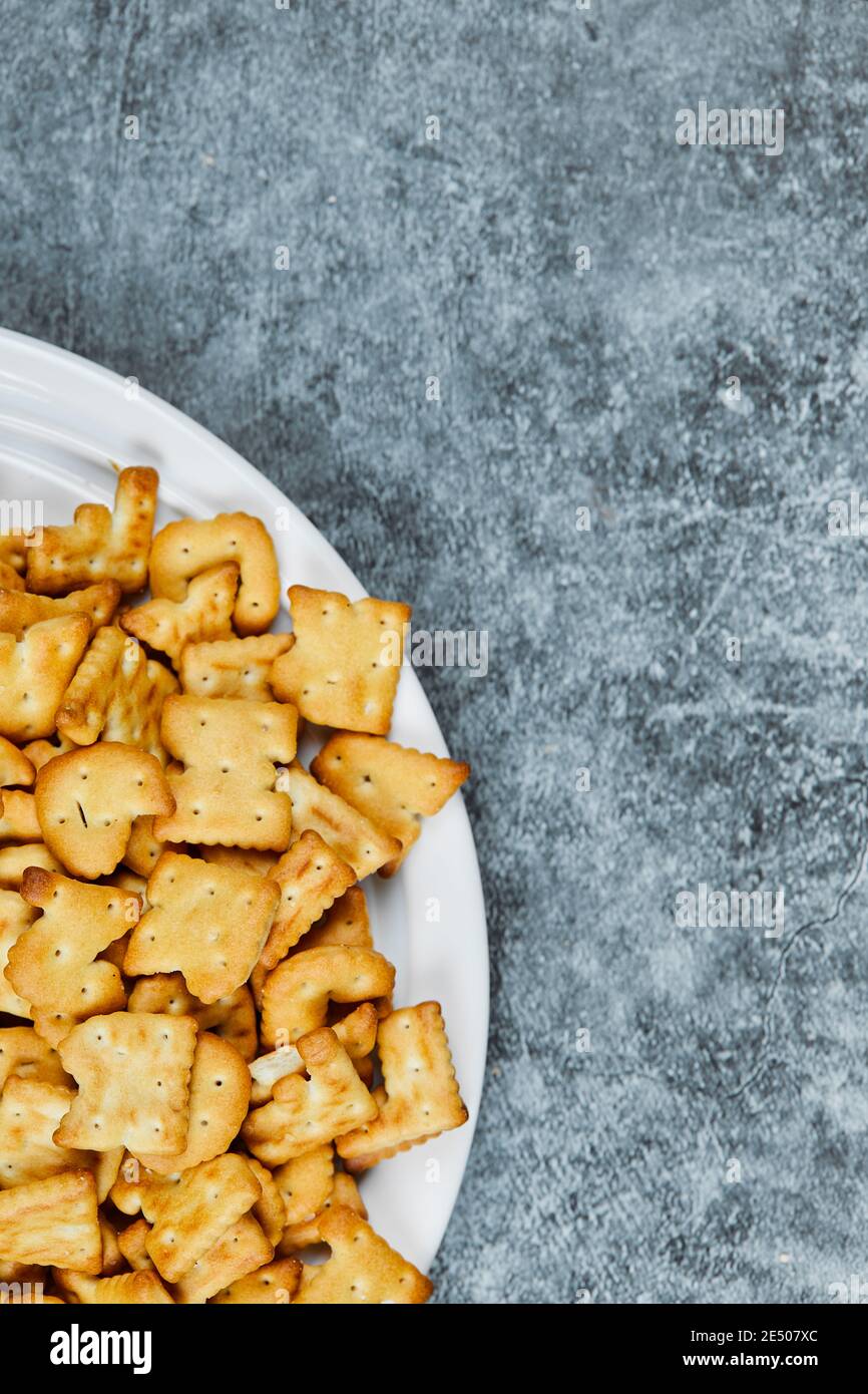 A plate of alphabet crackers on a marble background Stock Photo - Alamy