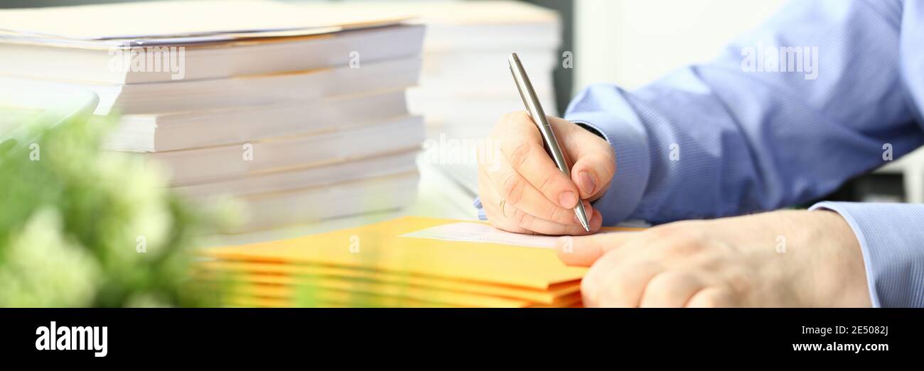 Office employee filling out a form on an envelope Stock Photo - Alamy