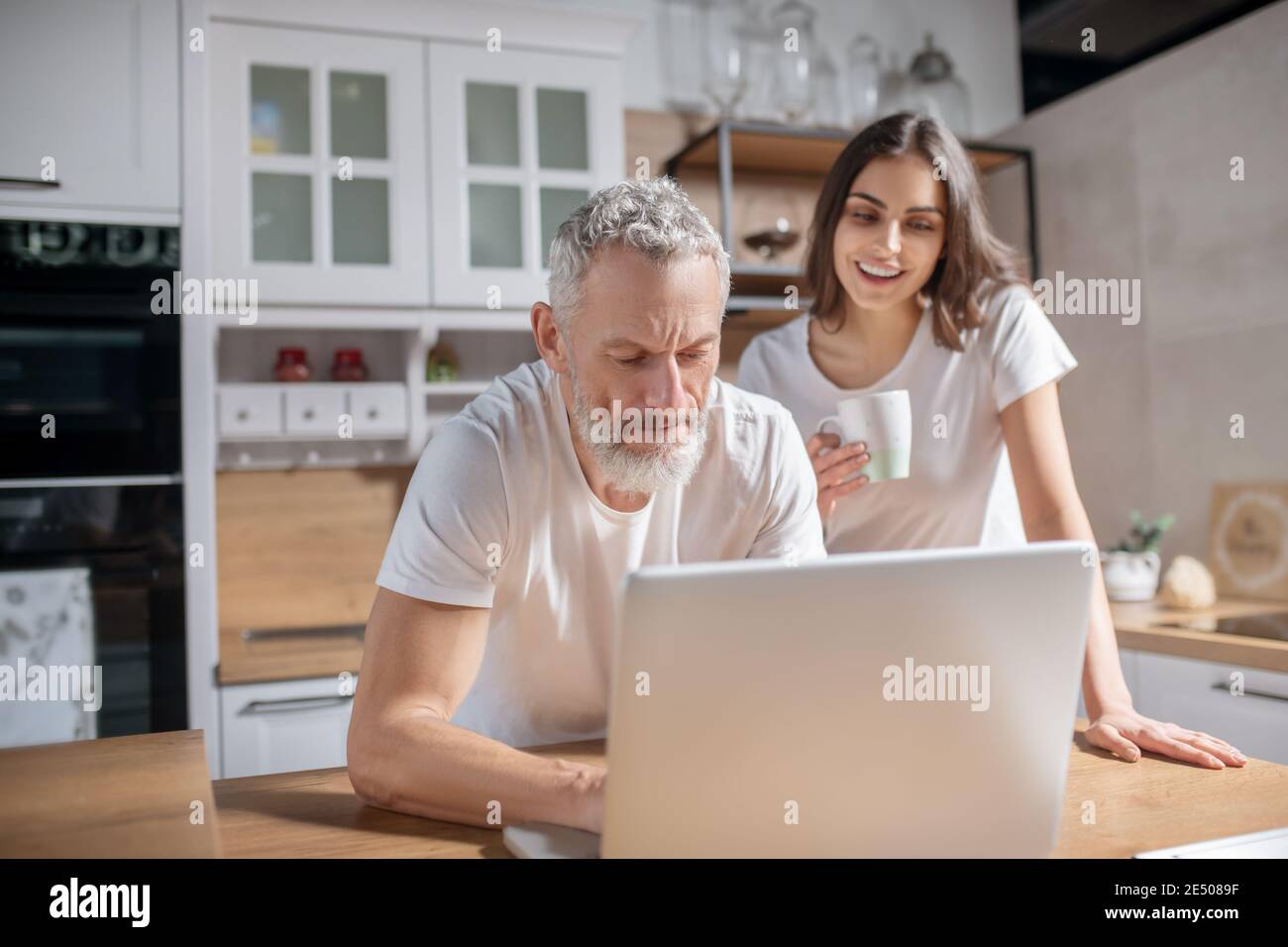 Couple checking morning emails while having coffee Stock Photo - Alamy