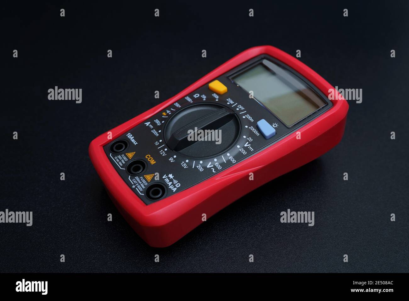 Red digital multimeter on black background - Multimeter is an ...