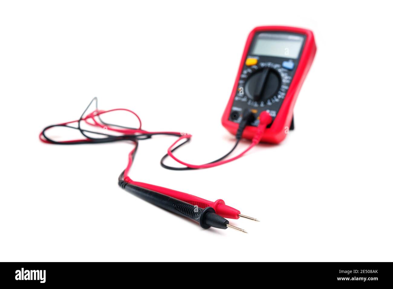 Red digital multimeter with probes on white background - Multimeter is ...
