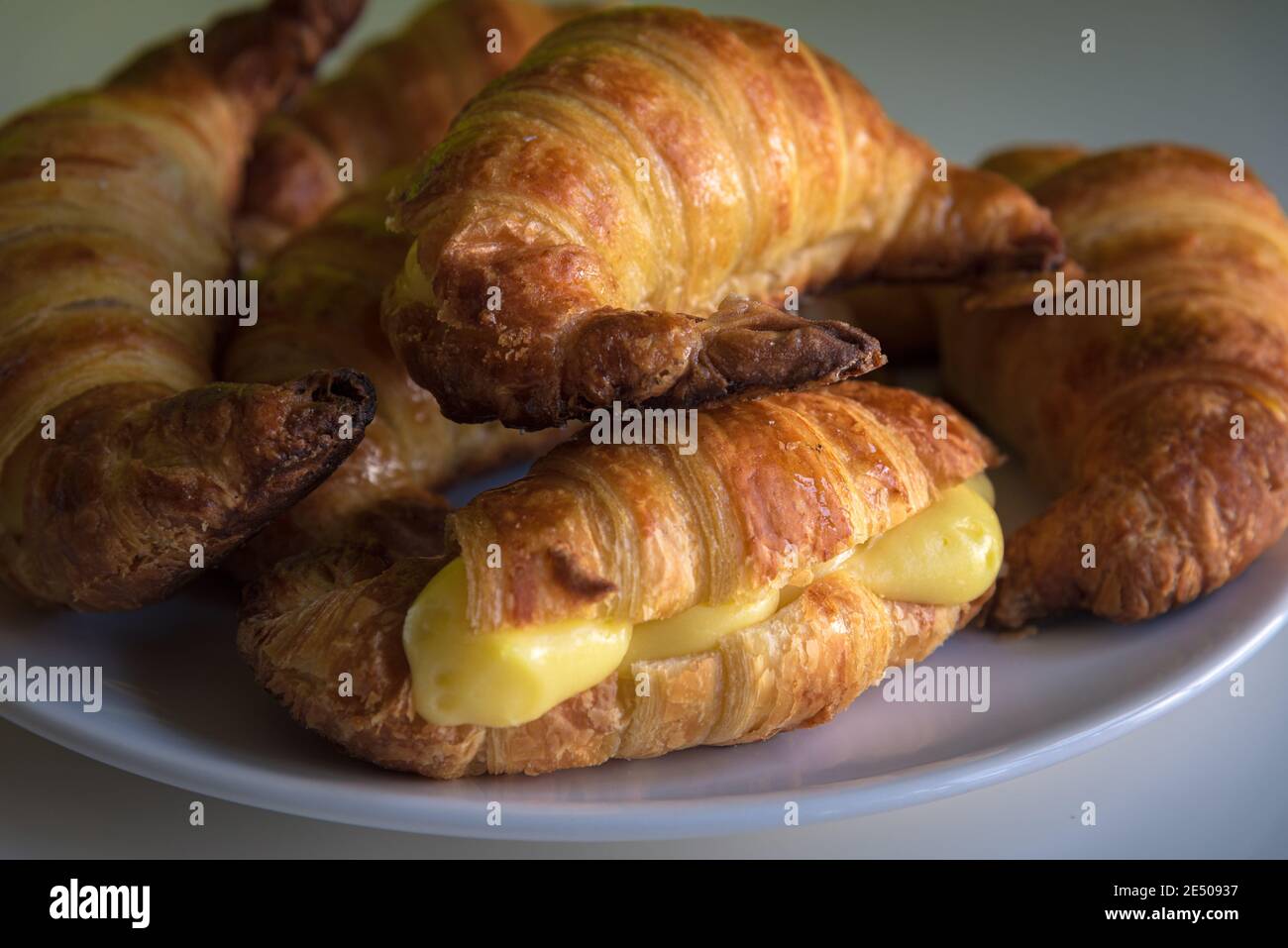 Home baked croissants filled with custard cream Stock Photo - Alamy