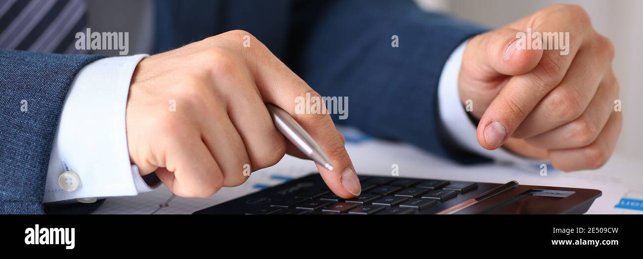 Adult businessman is making report at workplace Stock Photo - Alamy