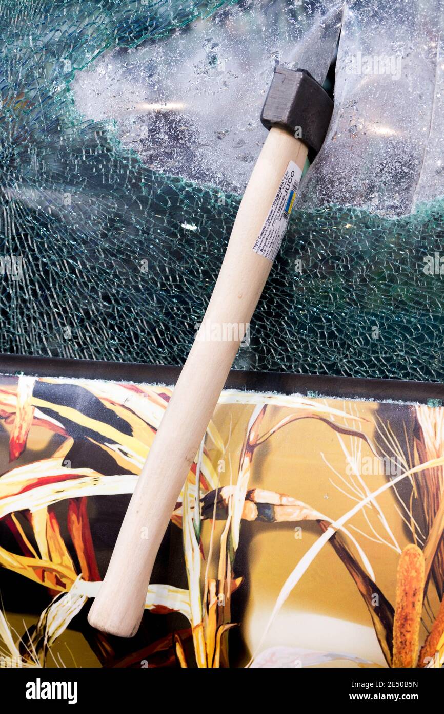 Axe in the glass door of the machine Stock Photo - Alamy