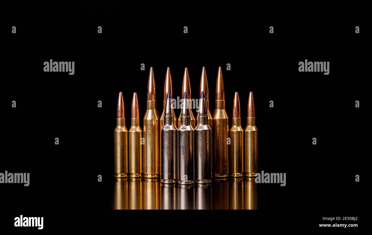 Bullet isolated on black background with reflexion. Rifle bullets close ...
