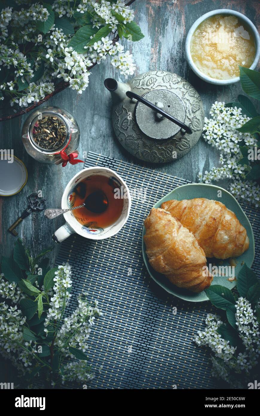 flatlay food background - breakfast on table with tea, croissants and ...