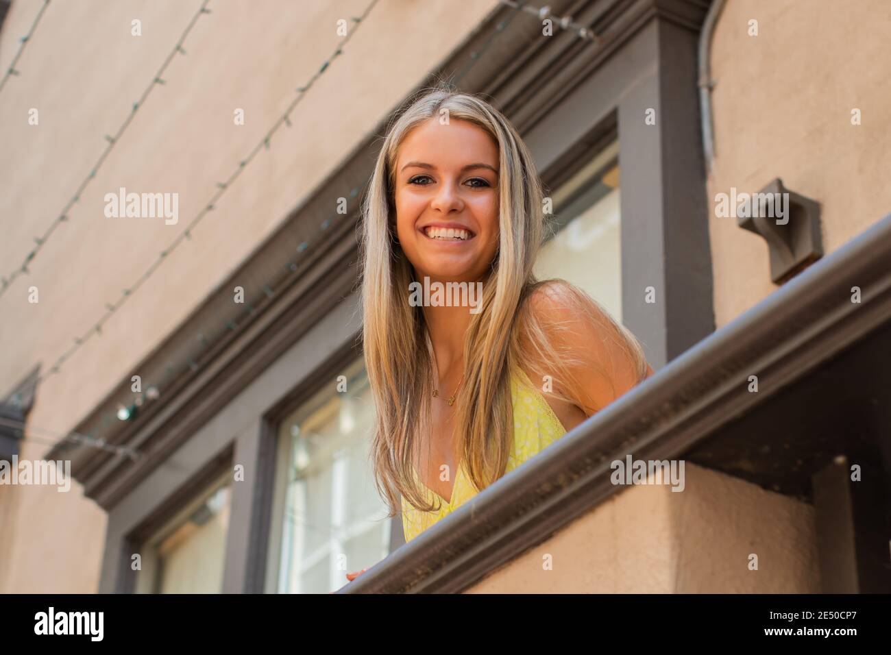 Girl looking out from balcony hi-res stock photography and images - Alamy