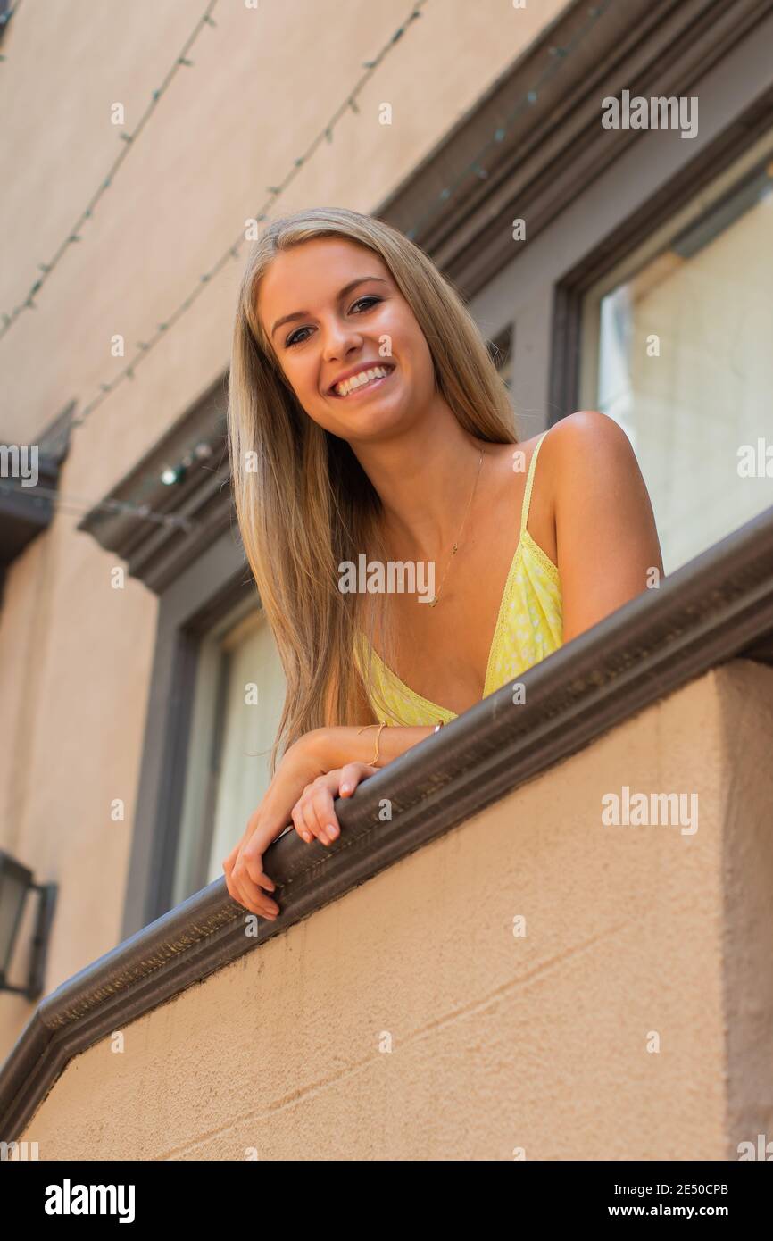 Girl looking out from balcony hi-res stock photography and images - Alamy