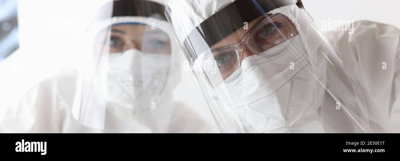 Bottom view of doctors in anti-plague protective suits and screens at ...
