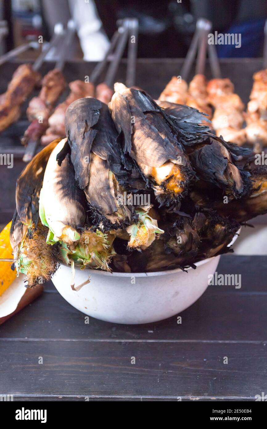 Cooking corn on the grill in the skin Stock Photo - Alamy