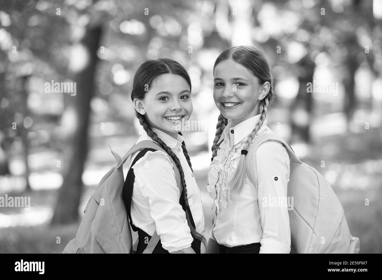 Clever friends. back to school. small school girls walk in spring ...