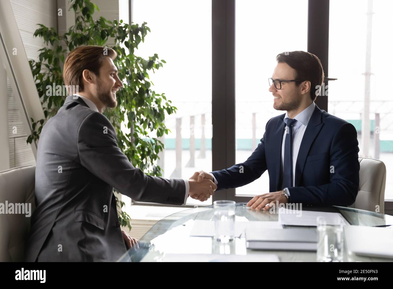 Side view happy business partners shaking hands, making deal Stock ...