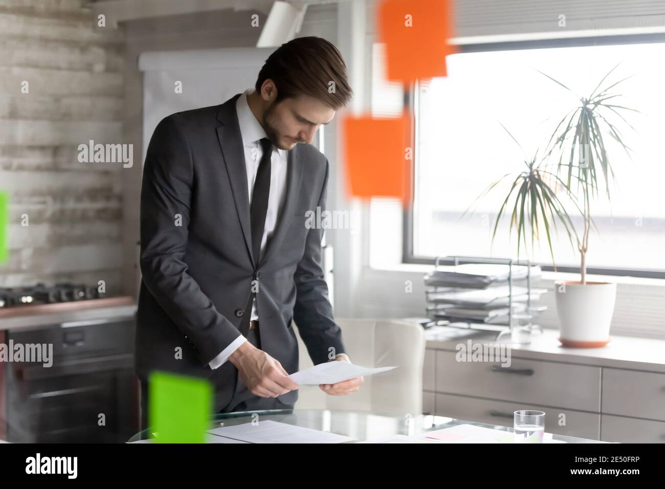Serious business man reading documents hi-res stock photography and ...