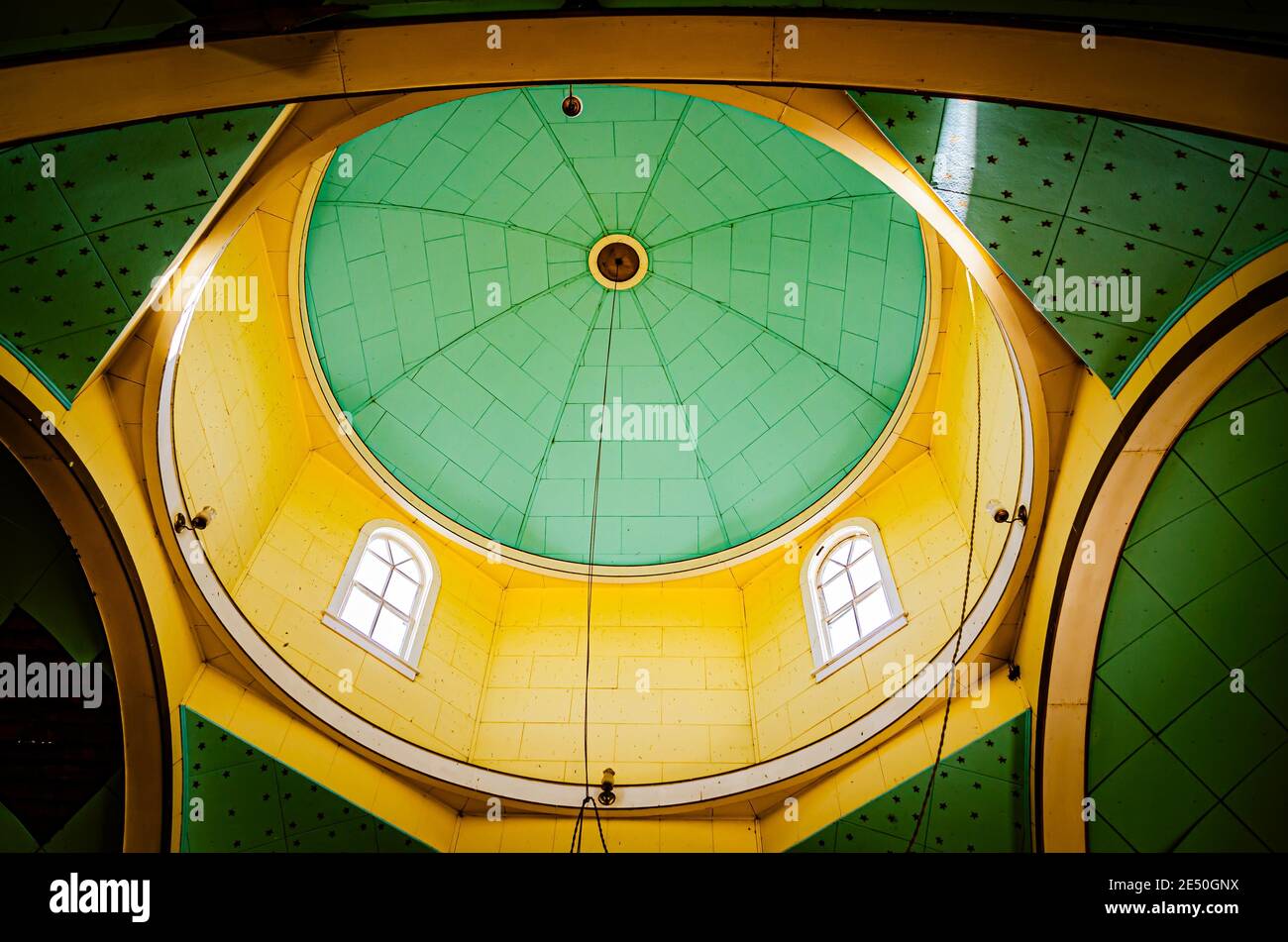 Low angle shot of the green and yellow dome of a church captured during ...