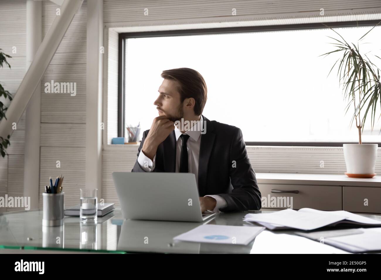 Serious employee looking aside hi-res stock photography and images - Alamy
